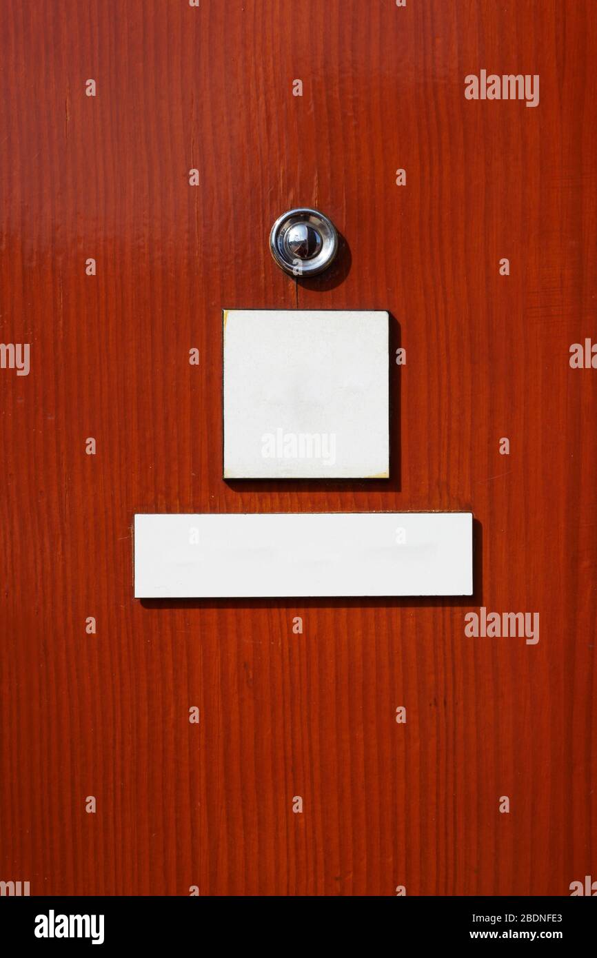 Spy on a door with white signs Stock Photo - Alamy