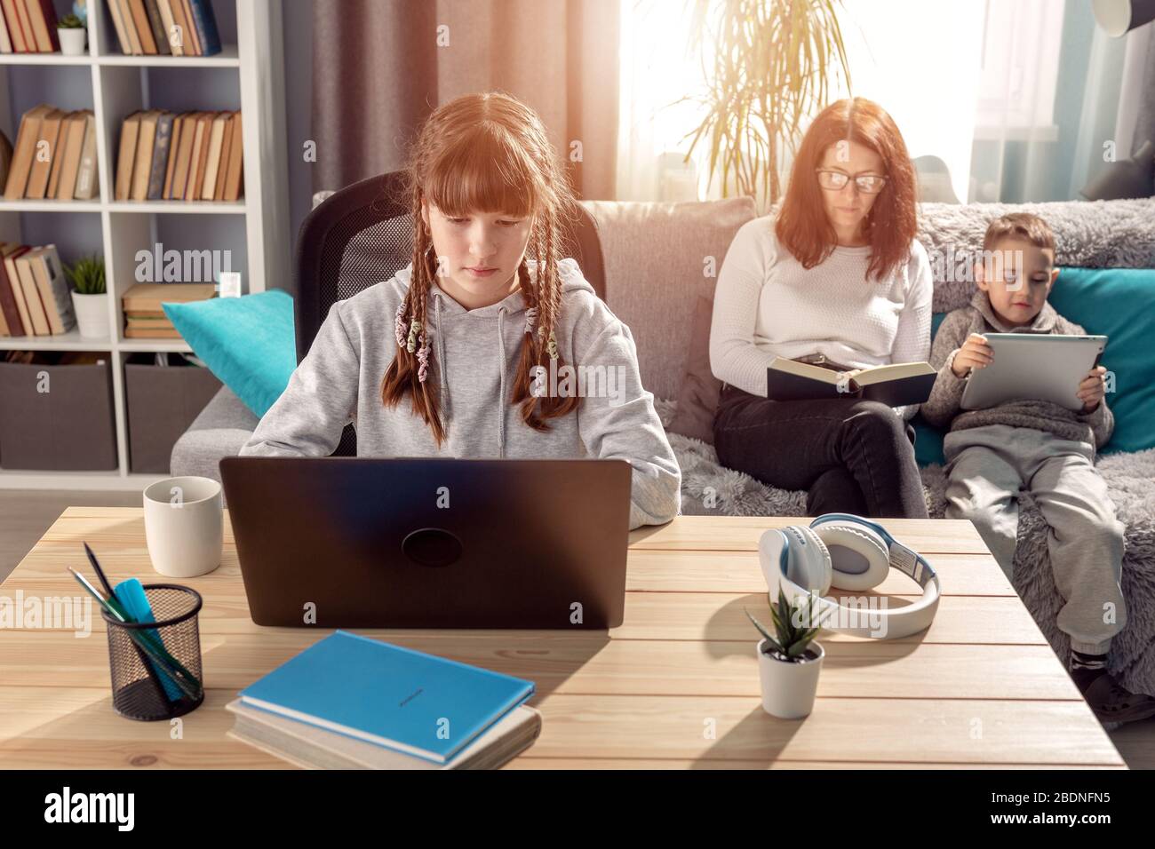 Family members busy with stuff Stock Photo - Alamy