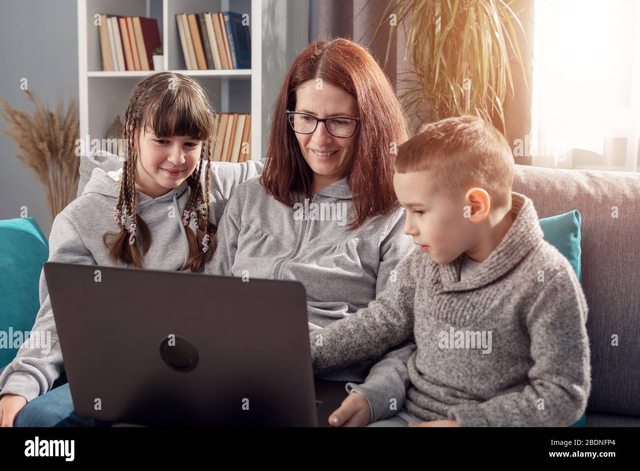 Happy family using laptop together Stock Photo - Alamy