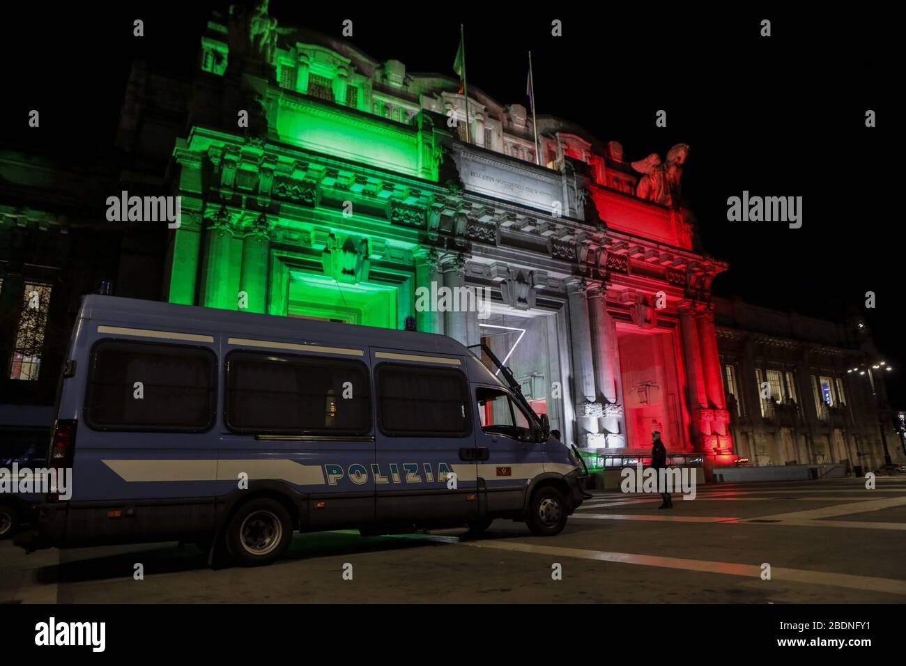 The facade of Milan Central Station illuminated with the Italian flag ...