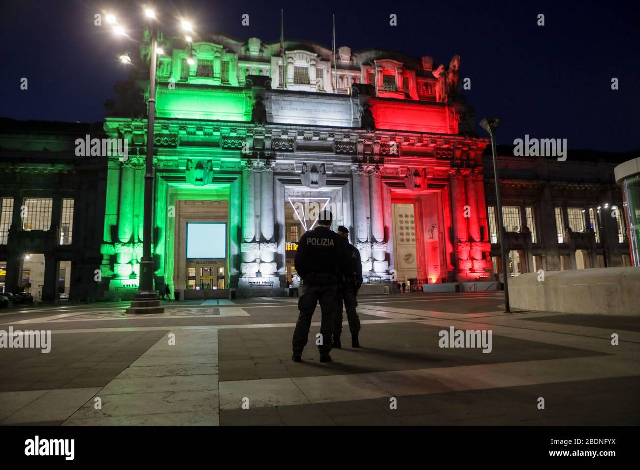 The facade of Milan Central Station illuminated with the Italian flag ...