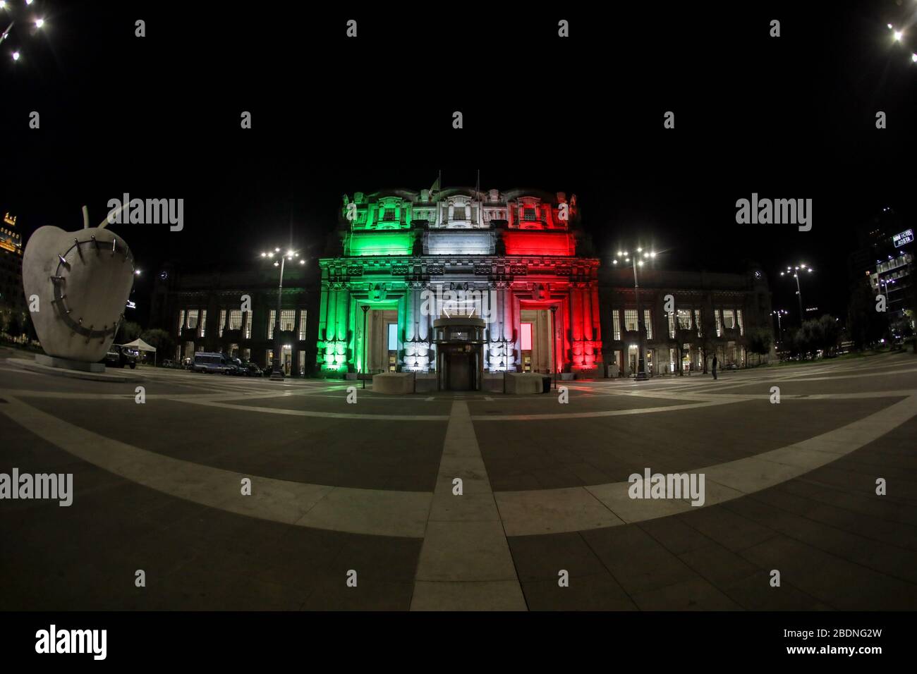 The facade of Milan Central Station illuminated with the Italian flag ...