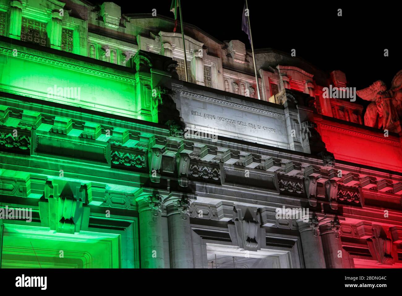 The facade of Milan Central Station illuminated with the Italian flag ...