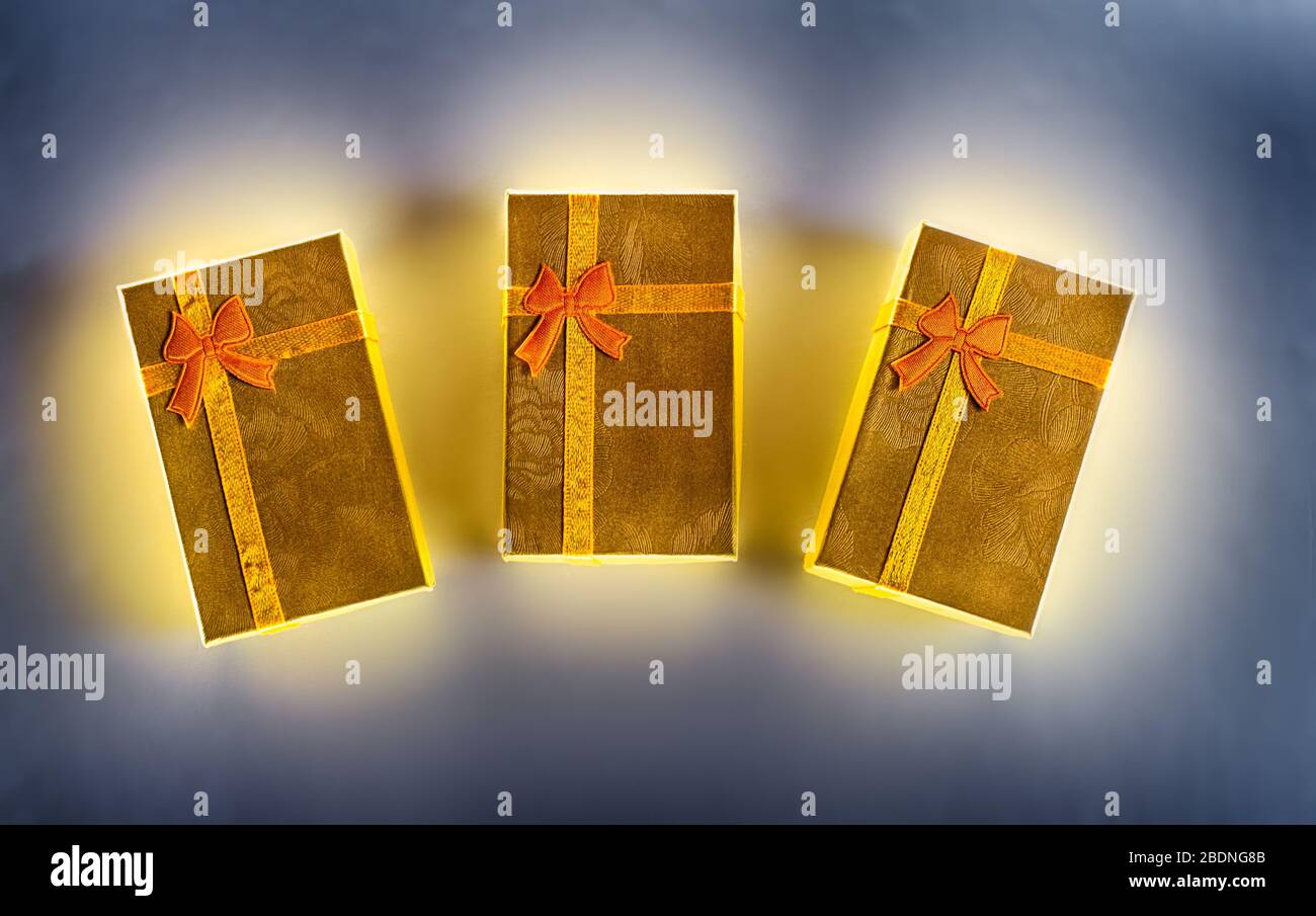 golden rectangular gift boxes on blue background Stock Photo - Alamy