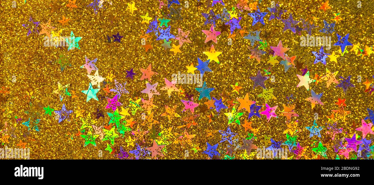 golden sparkles and multicolour stars background Stock Photo - Alamy