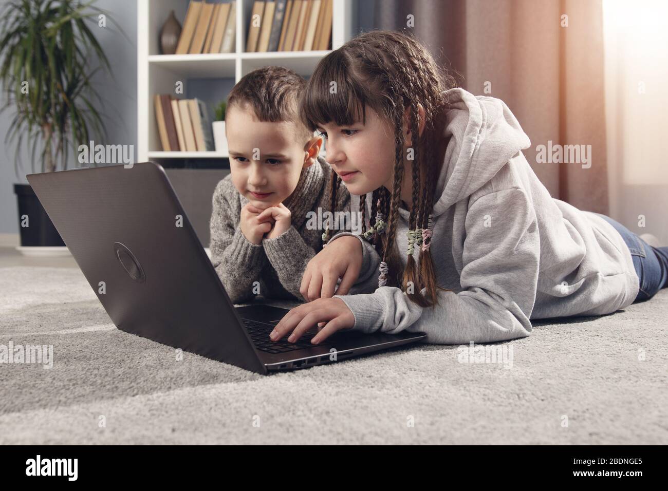 Two children using laptop Stock Photo - Alamy