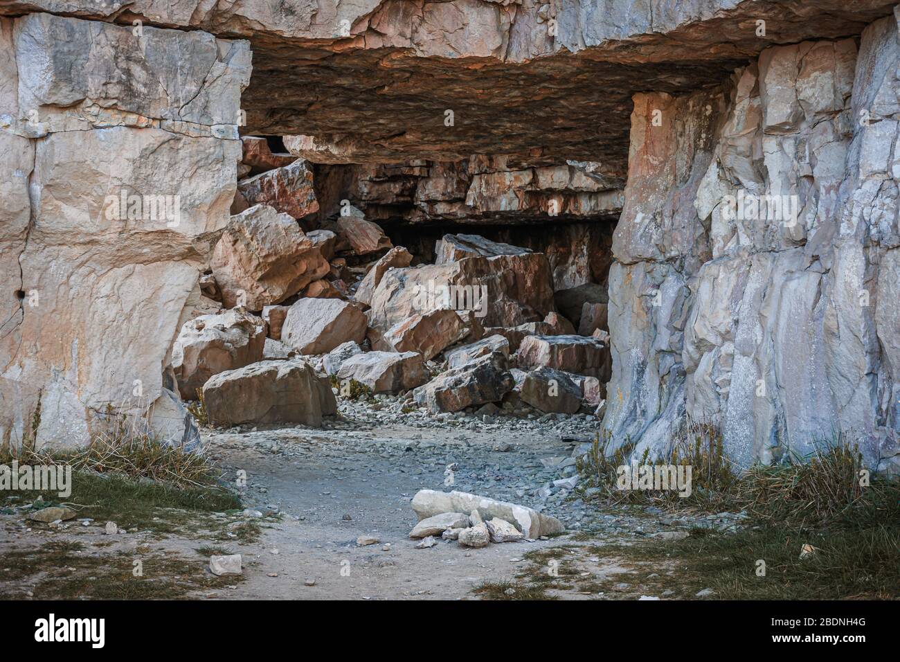 Fallen rocks through an opening at Winspit Quarry, Worth Matravers ...