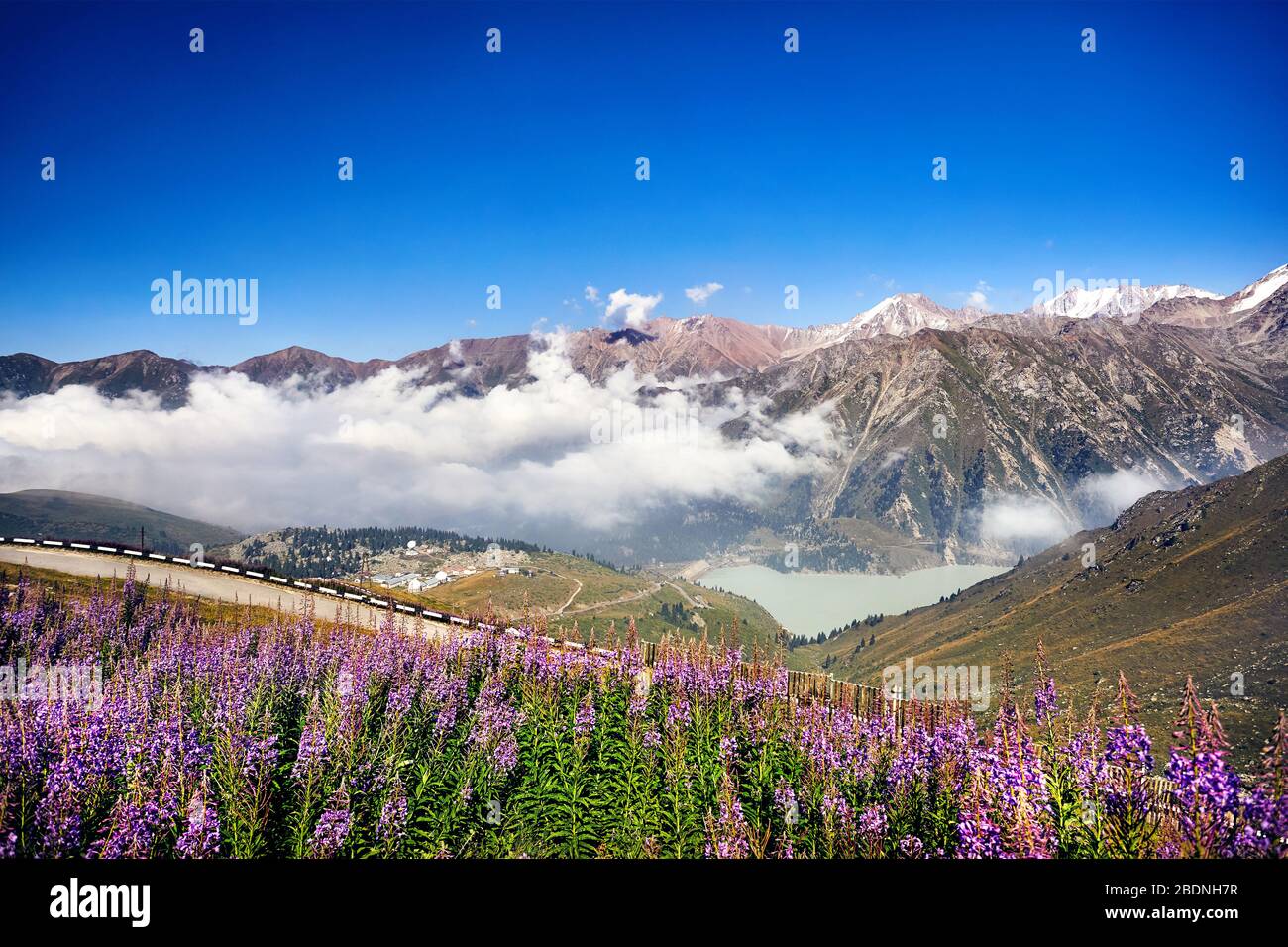 Beautiful landscape of lake and road in foggy mountains in Almaty ...