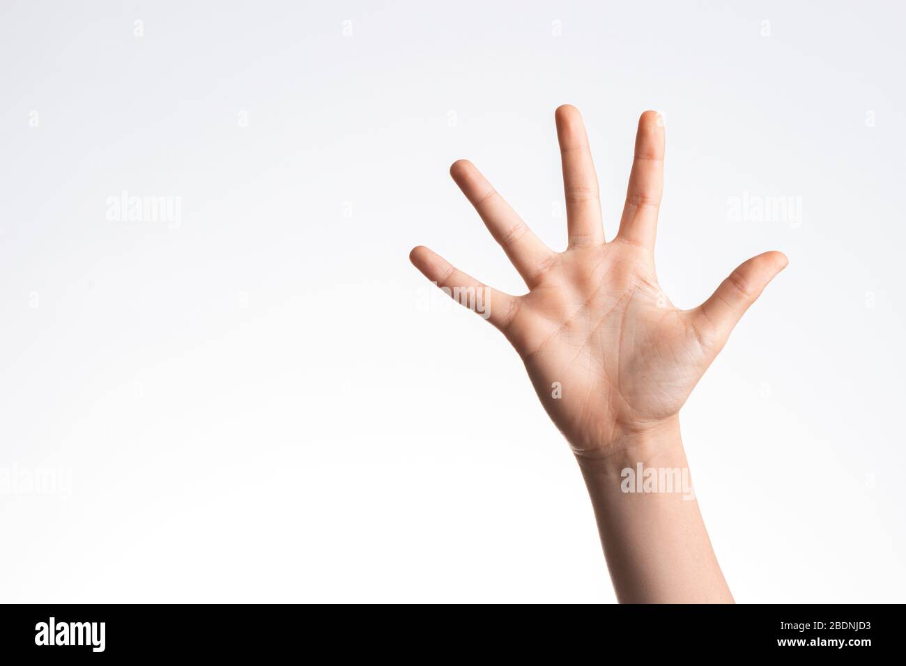 Kid hand showing and pointing up with fingers number five on white wall ...