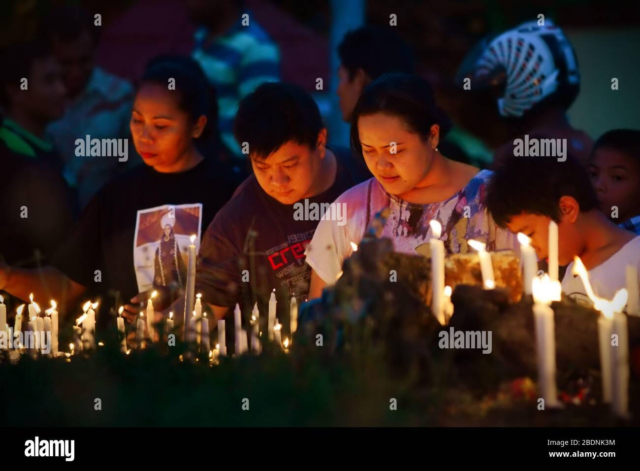 Pilgrims pray at Larantuka Cathedral Cemetery as a part of Holy Week ...