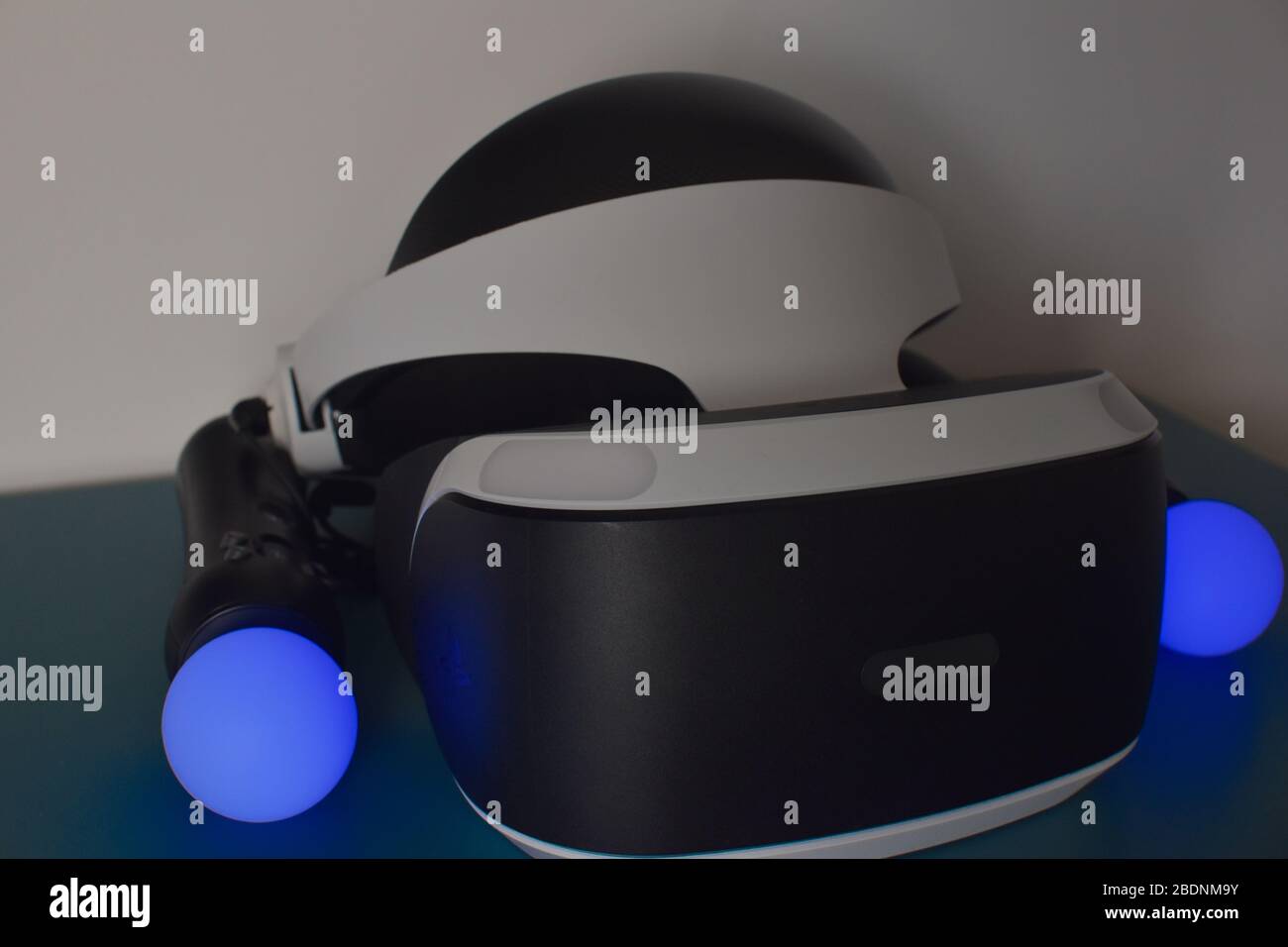 psvr with a blue move controller on each side on blue table and white ...