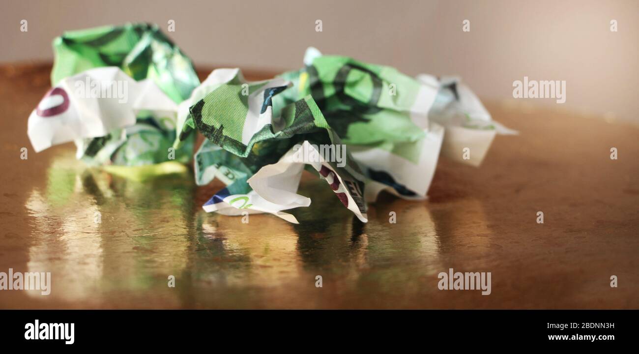 Crumpled 100 euro banknotes on golden background. Selective focus ...