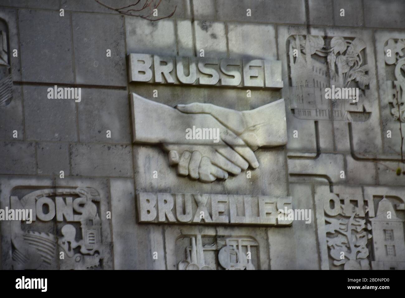Hand shaking sign in stone in Brussels Stock Photo - Alamy