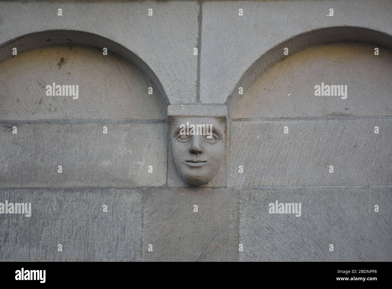 Stone statue of an androgynous face in Zurich Stock Photo - Alamy