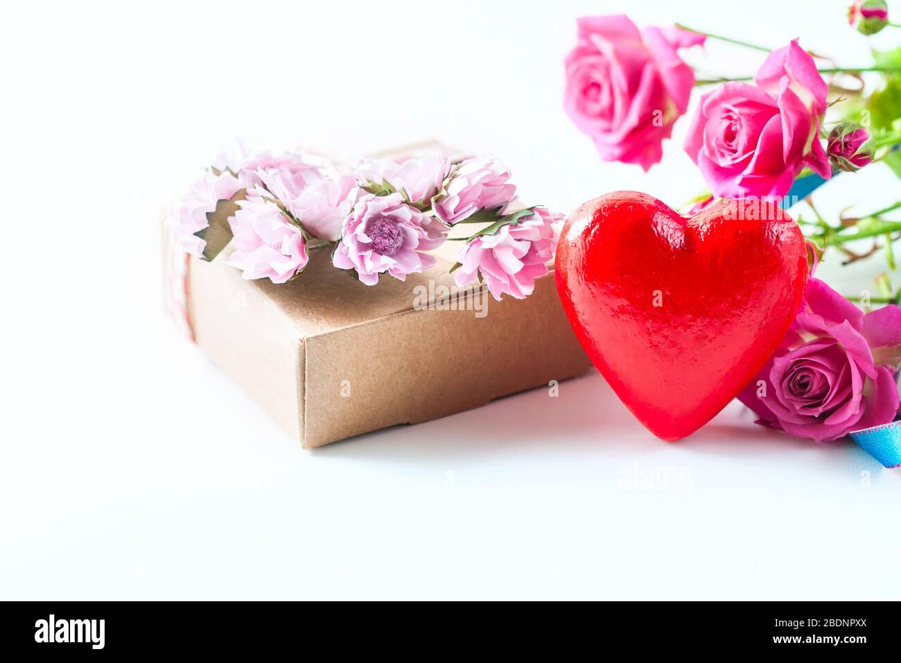Kraft box and pink roses on white table, concept of Valentine's Day ...