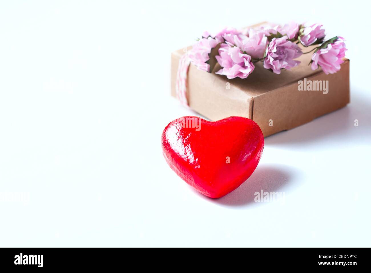 Kraft box and pink roses on white table, concept of Valentine's Day ...