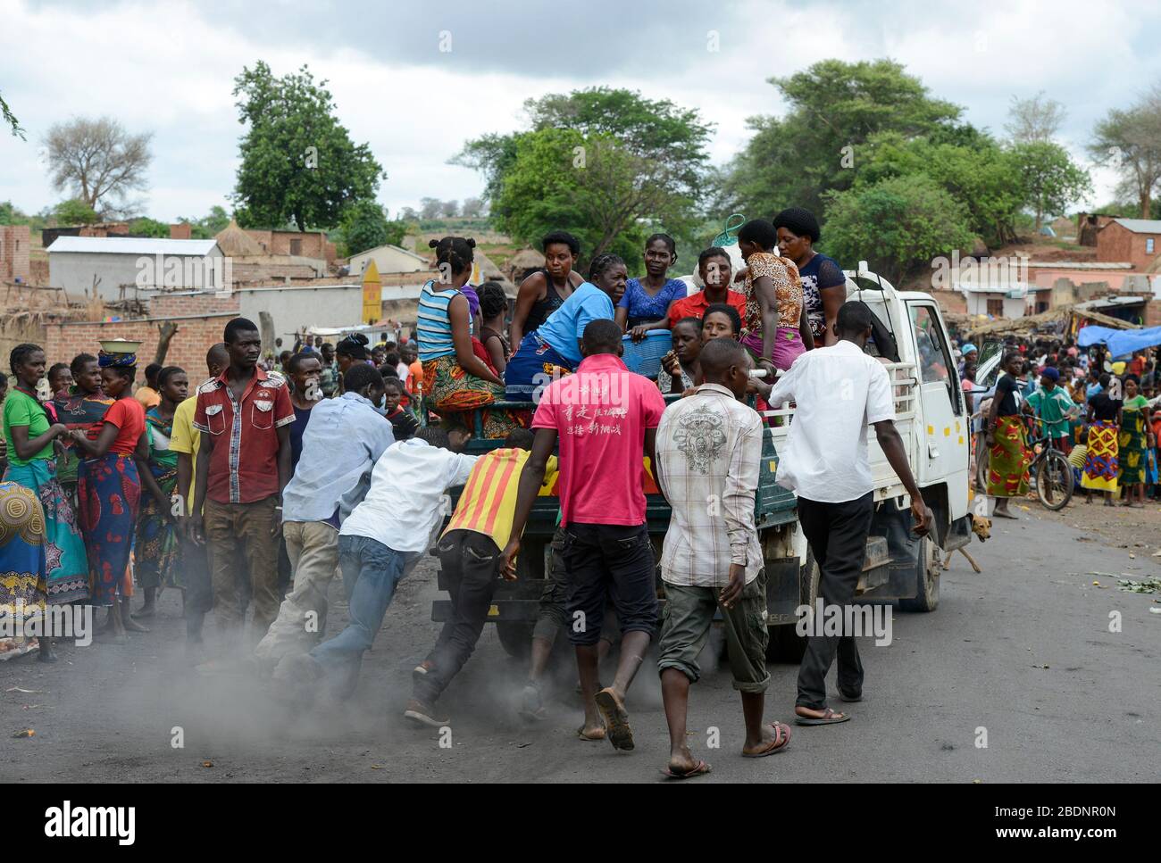 Zambia, Sinazongwe, rural market in village, men push a breakdown mini ...