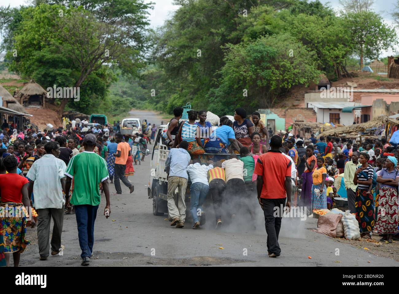 Zambia, Sinazongwe, rural market in village, men push a breakdown mini ...