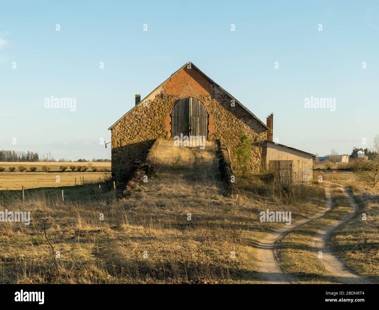 an old building in an overgrown field, a spring field and an old ...