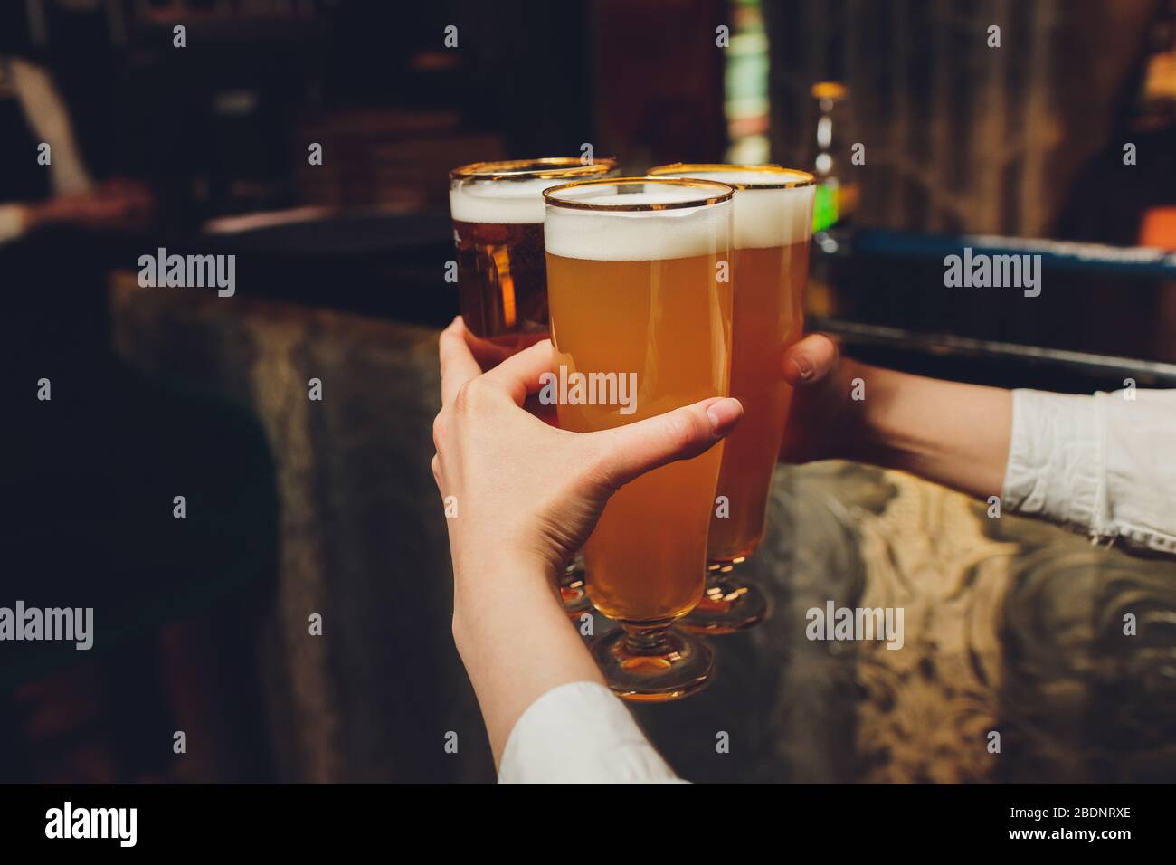 Woman holds a beer in hands hi-res stock photography and images - Alamy