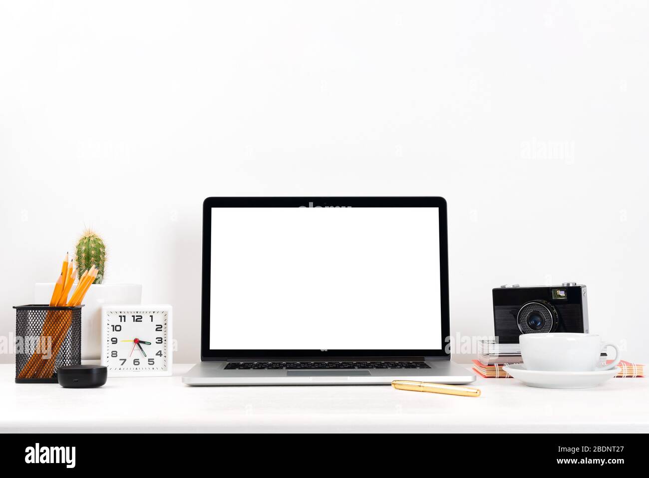 Workplace with laptop computer white blank screen on work table front ...