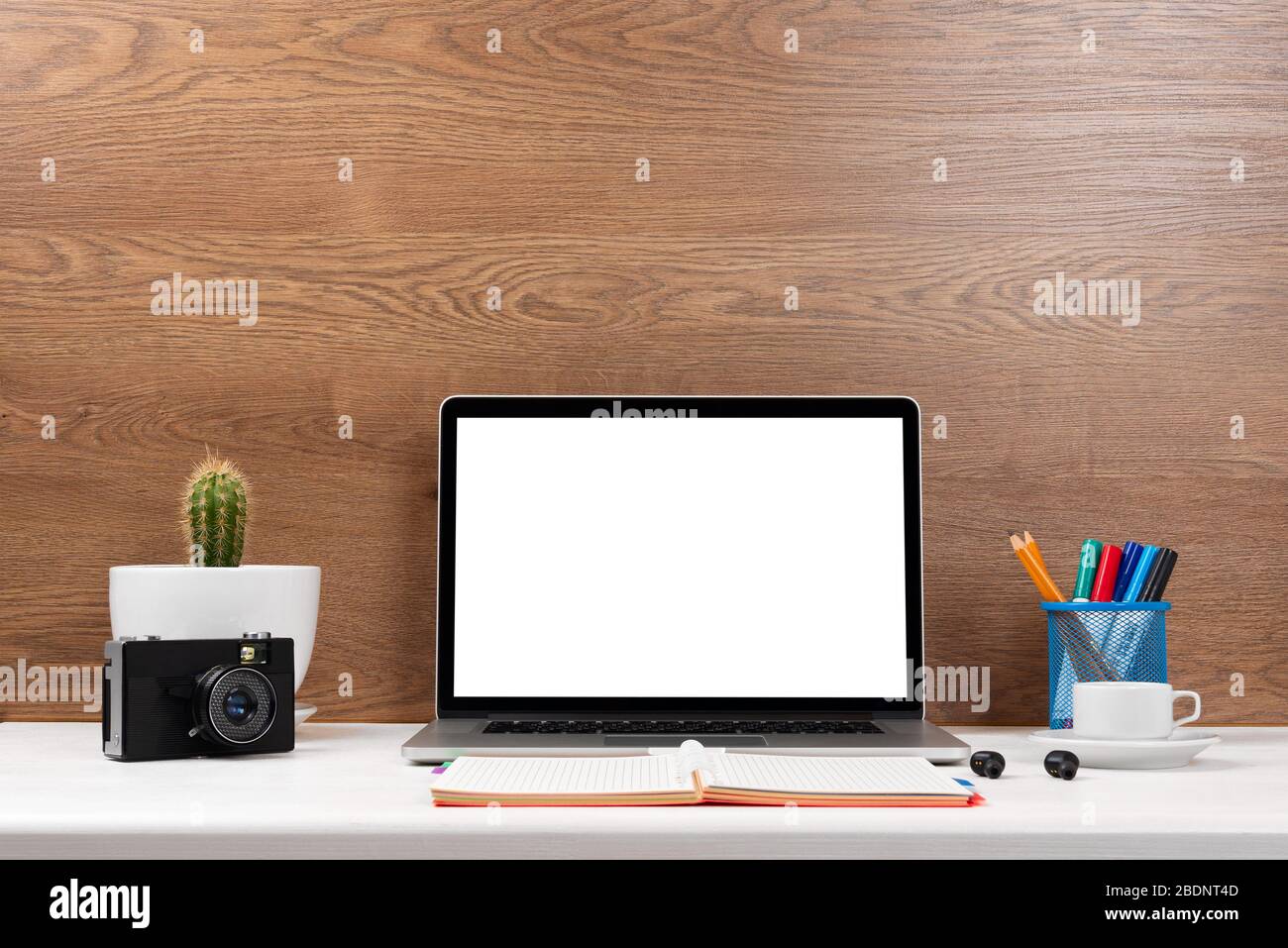 Workplace with laptop computer white blank screen on work table front ...