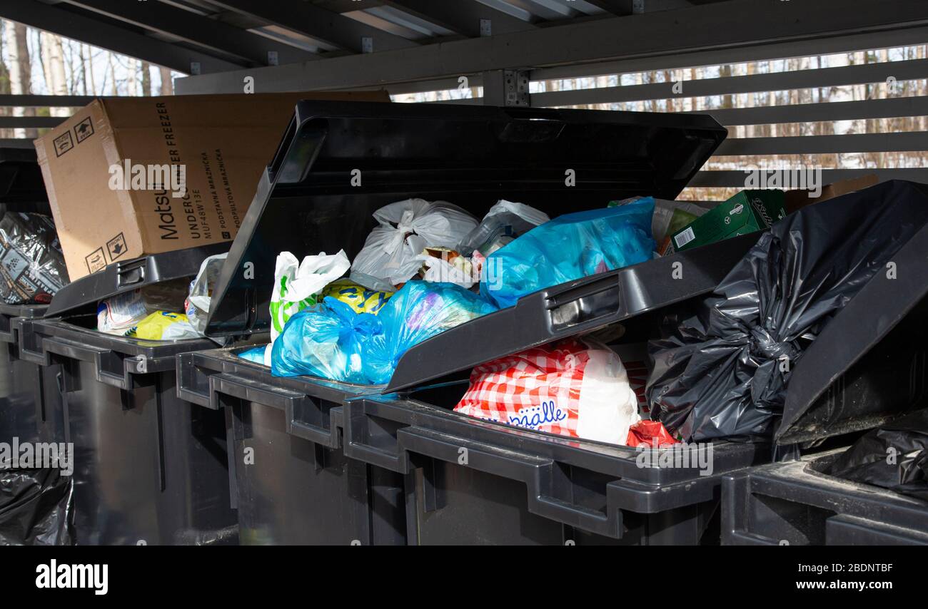 Overfilled 400 litre household trash bins at common waste collection ...
