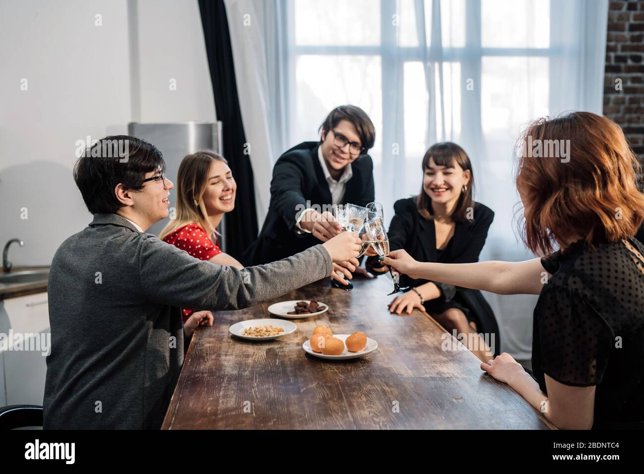Happy colleagues in office celebrate special event Stock Photo - Alamy