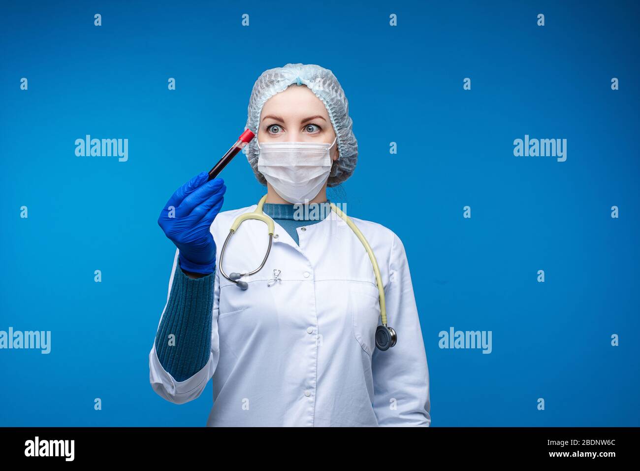 Beautiful woman doctor in white medical clothes, mask, phonendoscope ...