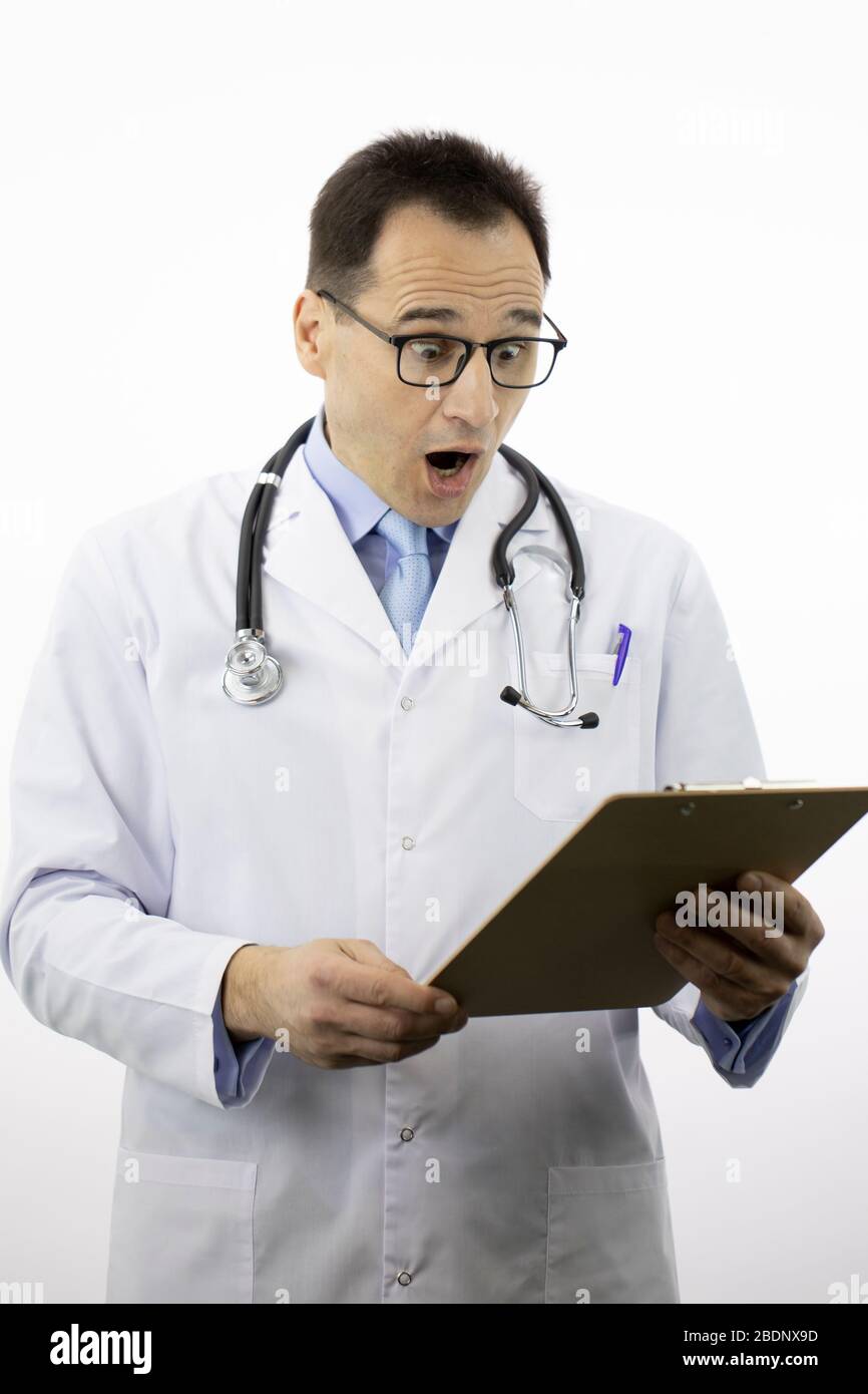 Shocked doctor looking on clipboard with patient's diagnosis, treatment ...