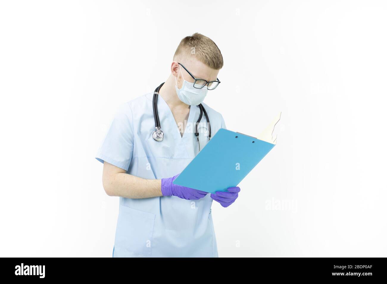 Lab technician in uniform checking patient's medical record on ...