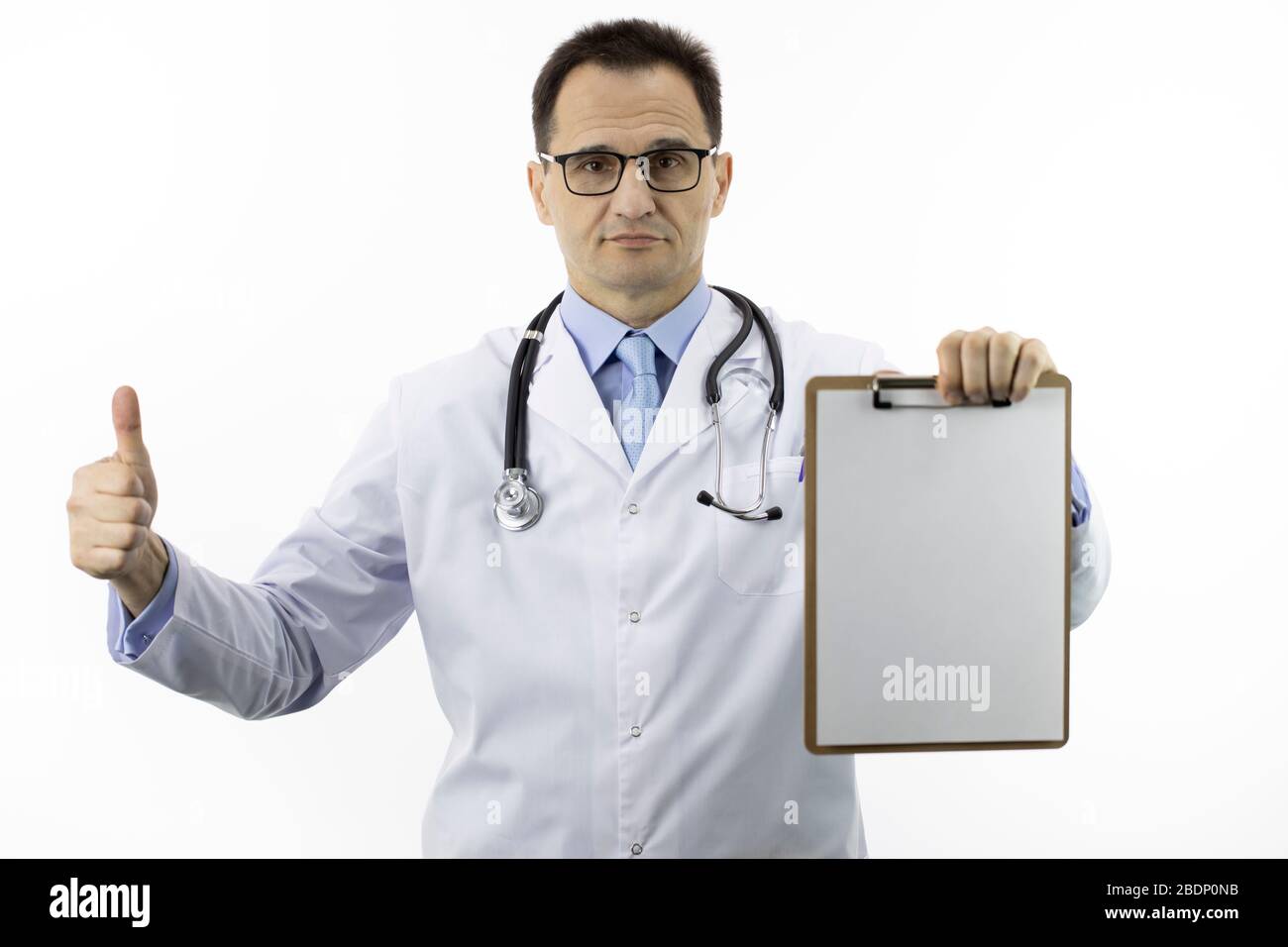 Doctor showing like sign holding blank clipboard. Approved by doctors ...