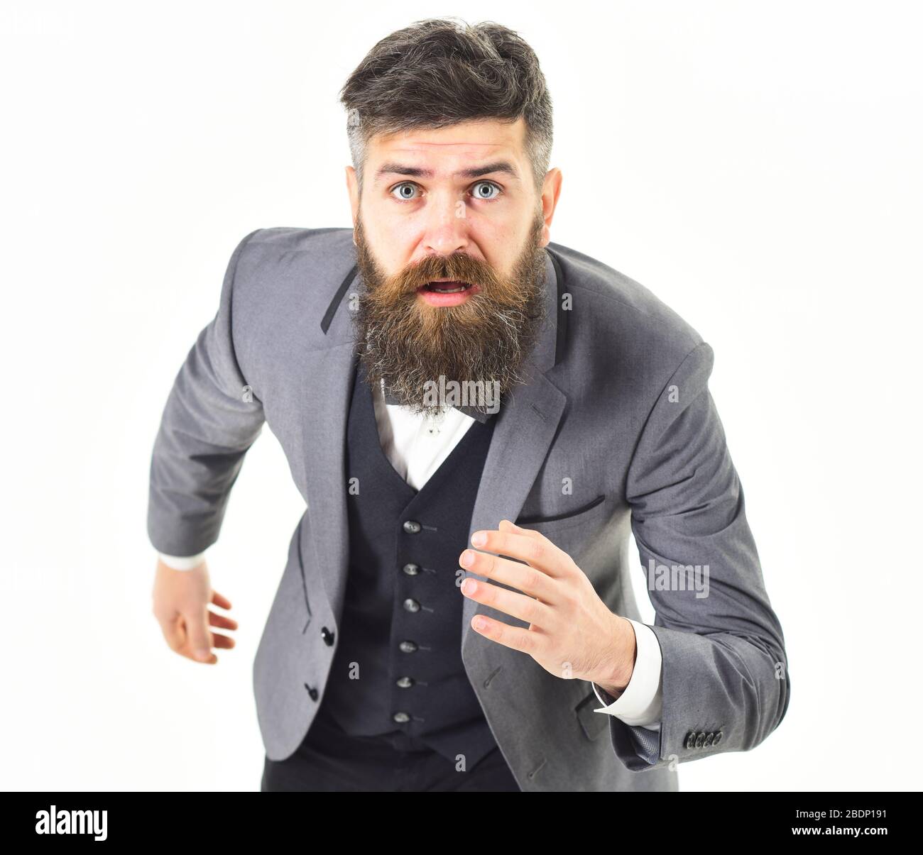 Shocked, frightened face. Hipster with long beard and open eyes wears ...