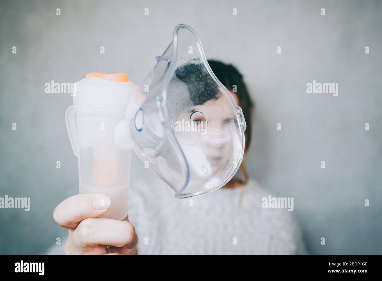 Young woman using a breathing mask Stock Photo - Alamy