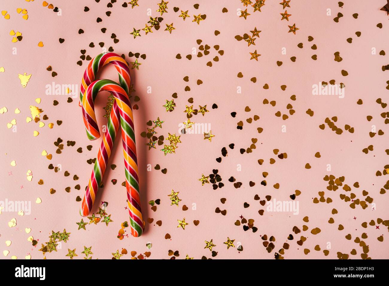 Colorful glitter sparkles candy cane and confetti on festive Christmas ...