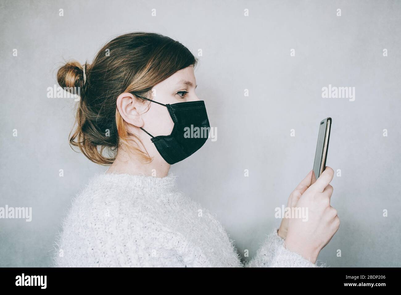 Phone mask woman message worried hi-res stock photography and images ...