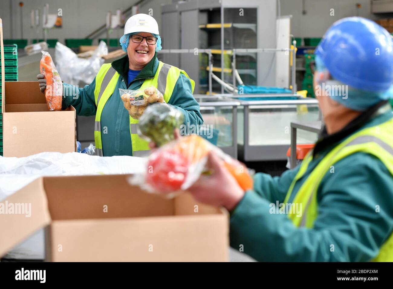 EDITORIAL USE ONLY Staff pack delivery boxes at Morrisons food ...