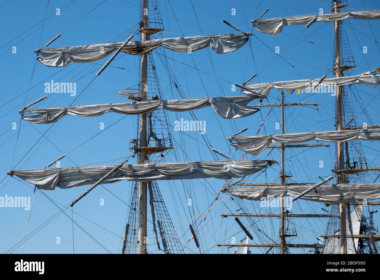 Wooden masts of sailing ships against the blue sky Stock Photo - Alamy