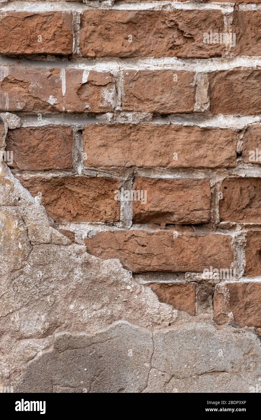 Old brick wall with plaster falling off of it Stock Photo - Alamy