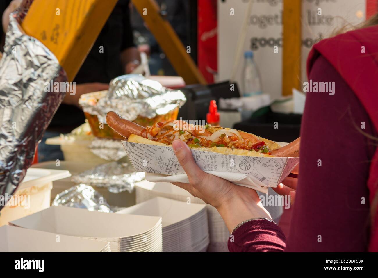 Hungry customer being served with delicious hot dog on street food ...