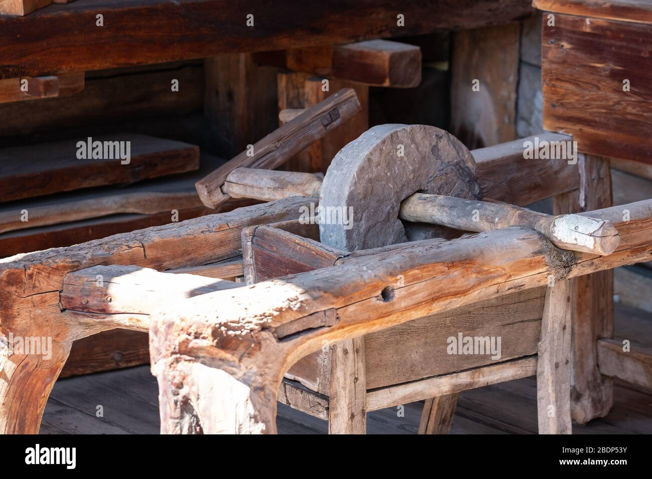 Photo of an old manual grinding stone with a wooden handle Stock Photo ...