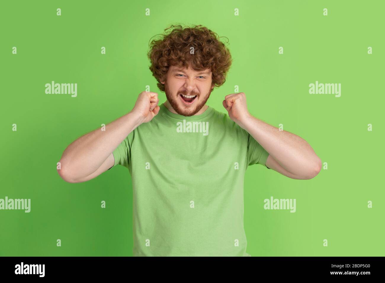 Crazy happy, celebrating. Caucasian young man's monochrome portrait on ...