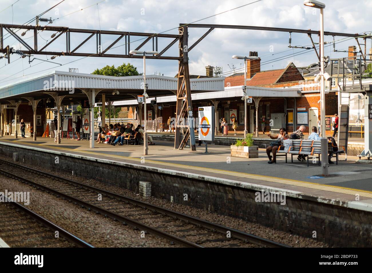 Commuters gather on one of the platforms at Hackney Downs train station ...