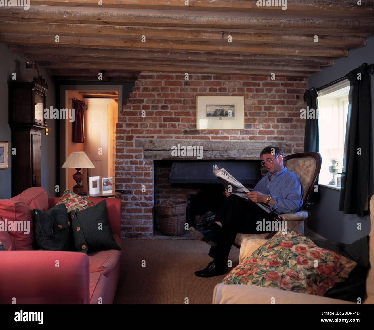 Owner reading newspaper in his livingroom FOR EDITORIAL USE ONLY ...