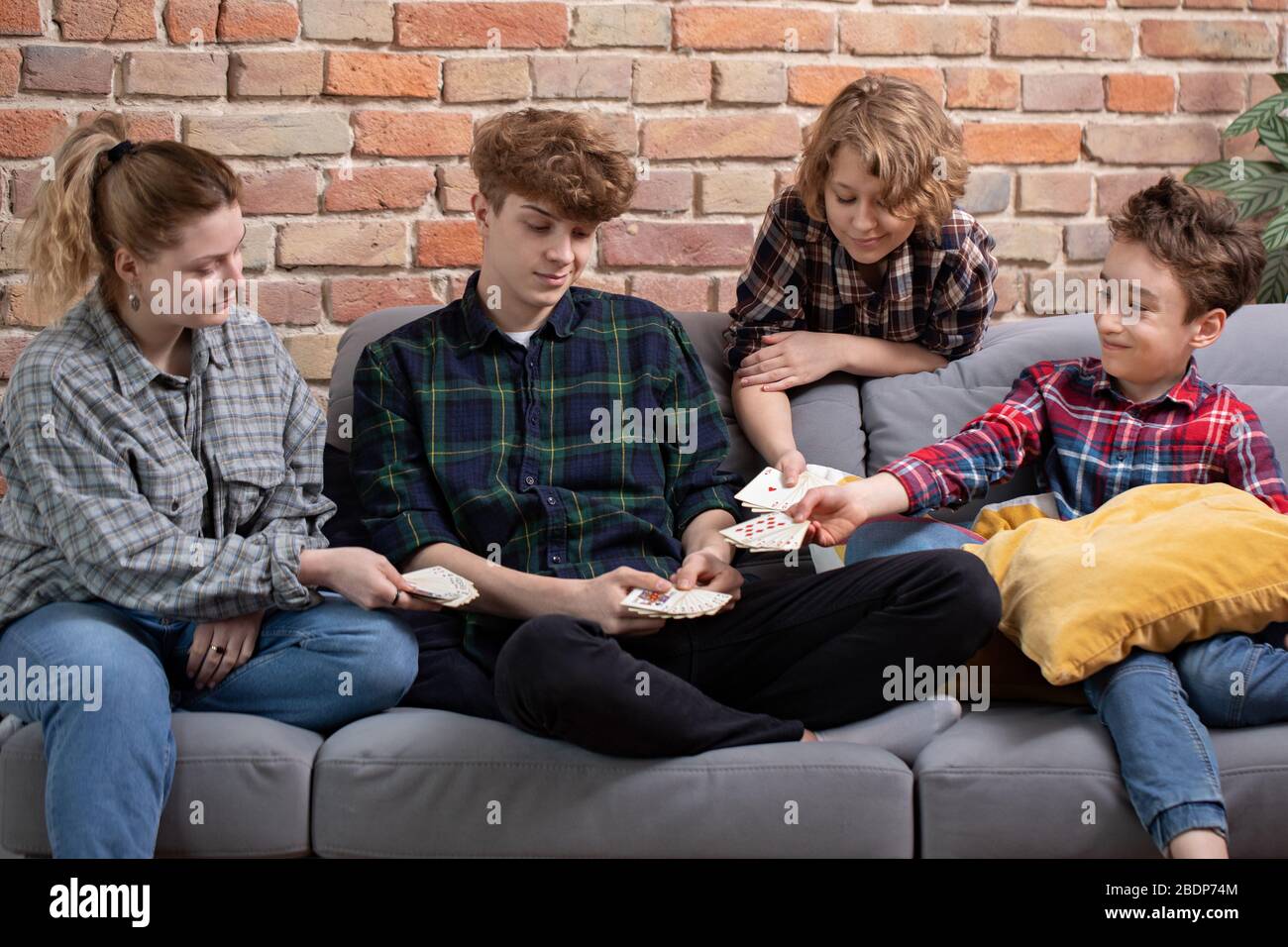 Group of young happy friends resting at home. young people spending ...