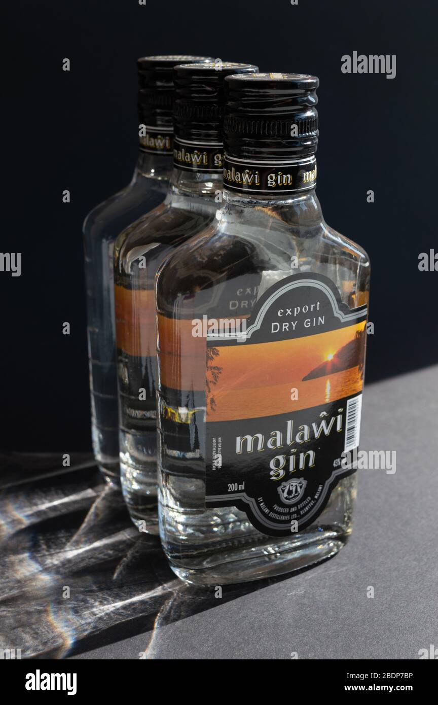 KYIV, UKRAINE - APRIL 03, 2020: Vertical photo of three 200 ml glass bottles of Malawi gin from ...