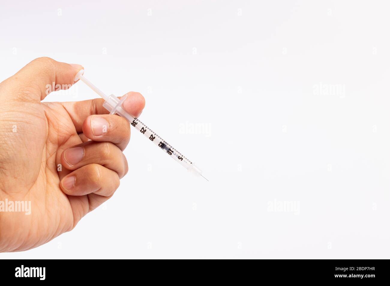Hand holding an insulin syringe before being used Stock Photo - Alamy