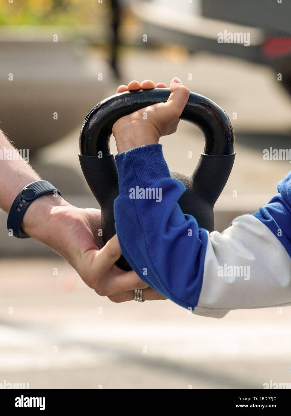 The childs hand lifts the weight, and the adults hand helps him Stock ...