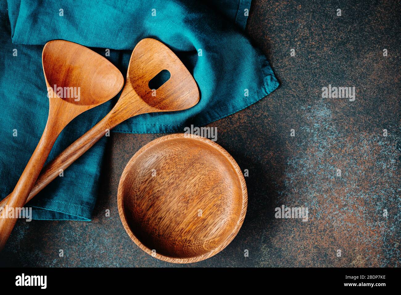 Cooking table background. Wooden kitchen tools and bowl with blue linen ...