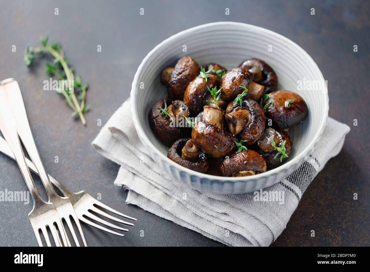 Grilled champignons with thyme in a ceramic bowl. Simple taste recipe ...